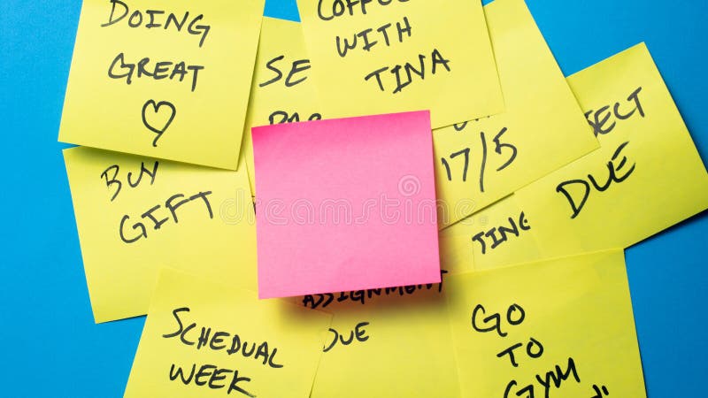 Sticky Notes on a Blue Wall with Pink Note in Center Stock Photo ...