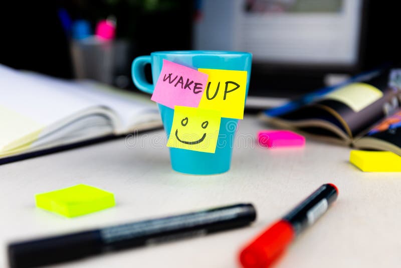 Sticky Notes on a Coffe Cup at Office Desk. Wake Up and Smile. Begin ...
