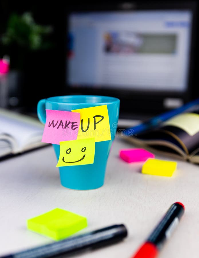 Sticky Notes on a Coffe Cup at Office Desk. Wake Up and Smile. Begin ...