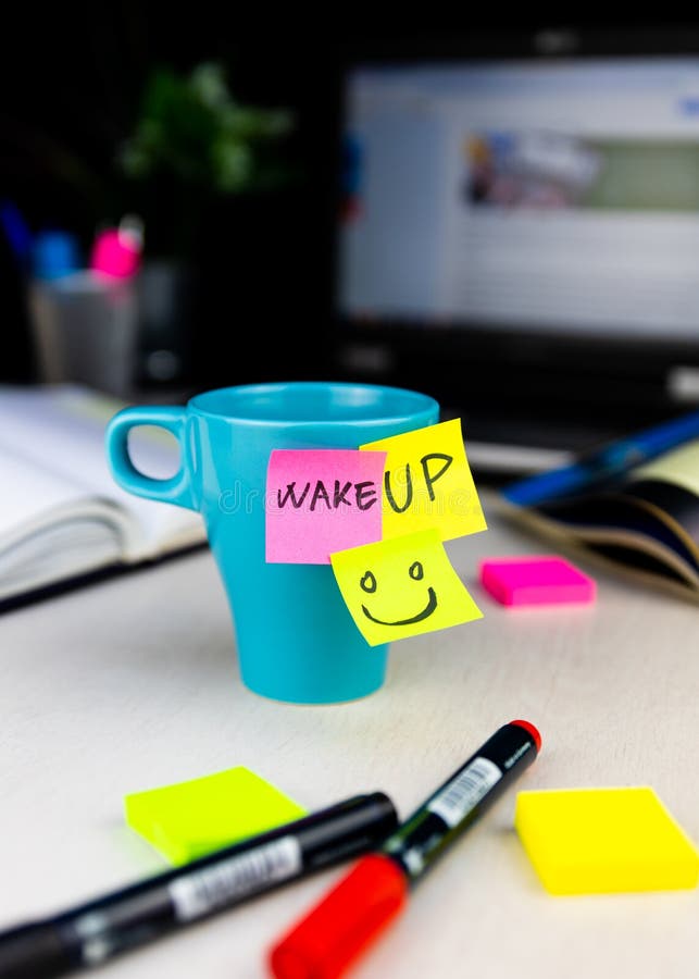 Sticky Notes on a Coffe Cup at Office Desk. Wake Up and Smile. Begin ...