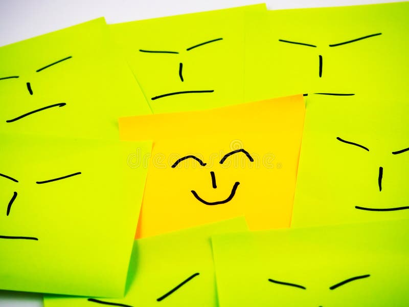 Sticky Notes with a Smiling Face in the Middle of Sad Faces Stock Photo ...