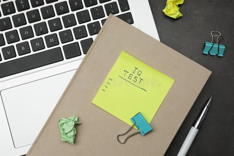 Sticky Paper with Words IQ Test, Notebook and Laptop on Black Table ...