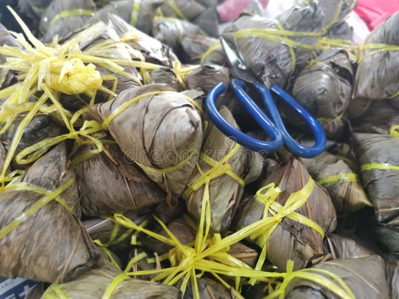 Sticky Rice with Meat Filling Wrapped with Bamboo Leaf Dumplings. Stock ...