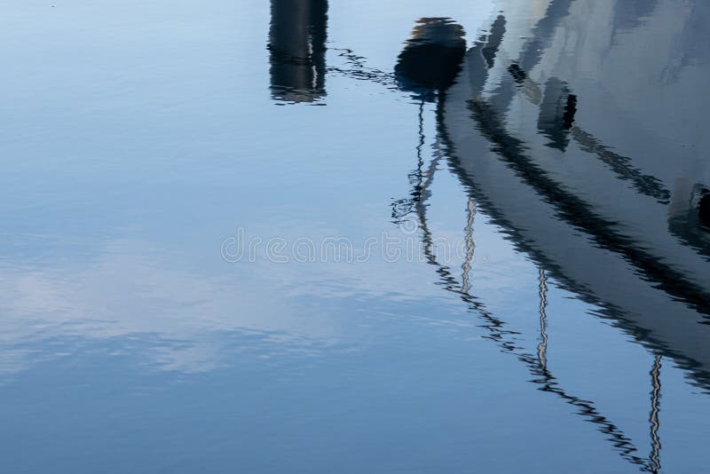 Distorted Reflection of a Ship with a Railing in Calm Water during ...