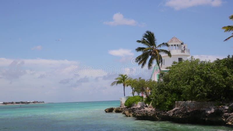 Still Camera View of Tropical Lighthouse Overlooking Clear Blue Ocean ...
