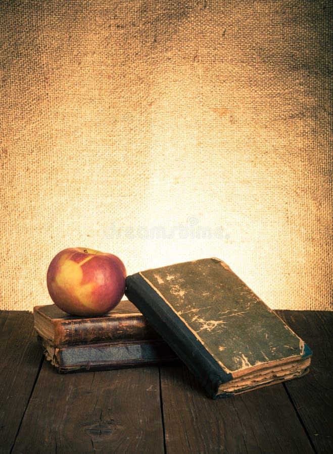 Still Life with Apple and a Stack of Old Books on Old Wooden Tab Stock ...