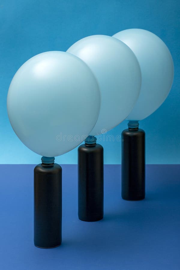 Still Life with a Balloons Dressed on a Black Bottles on a Blue ...