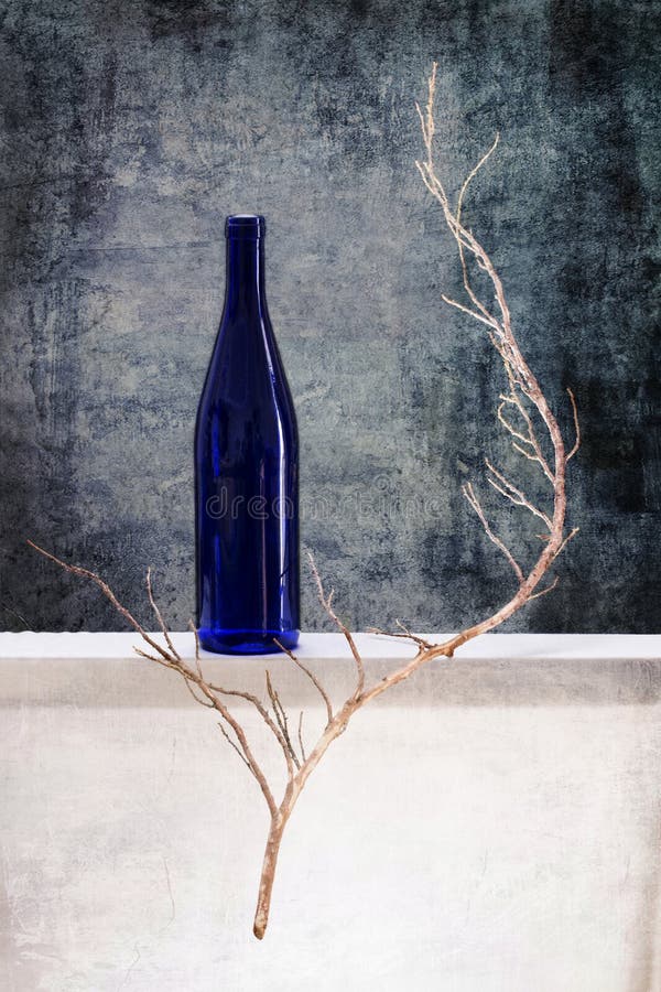 Still Life with a Bottle and a Dry Tree Branch Stock Photo - Image of ...