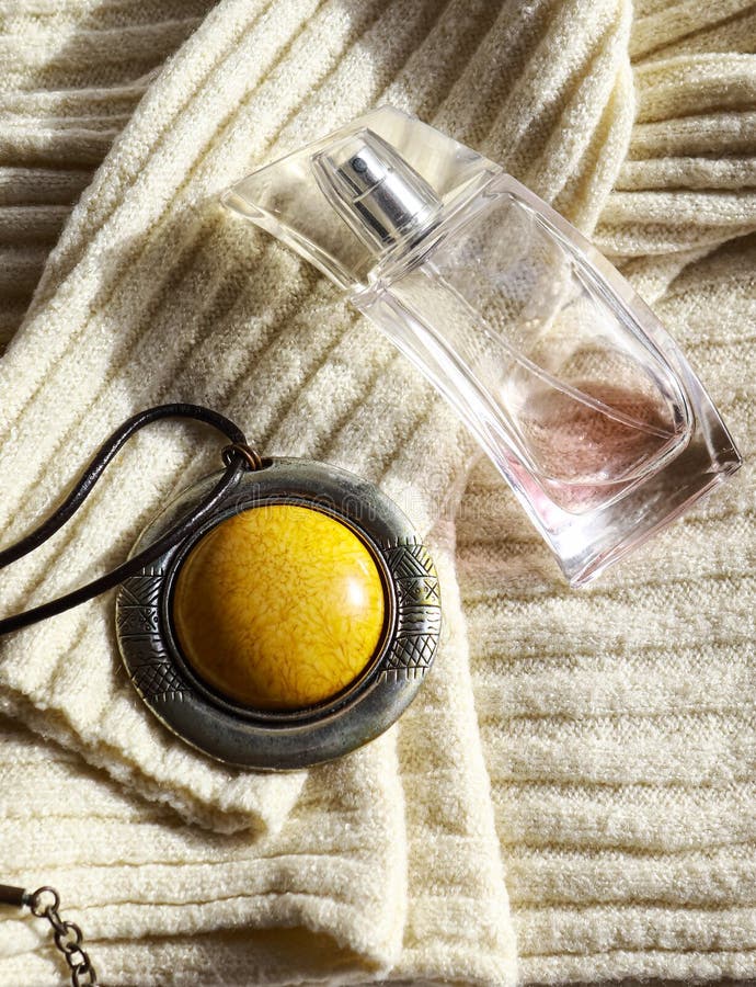 Still Life with Cardigan, Perfume and Pendant Stock Photo - Image of ...