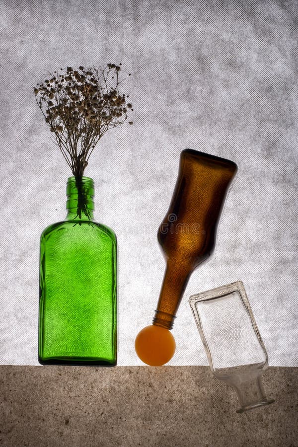 Still Life with Colored Bottles and a Dried Plant Twigs Stock Photo ...