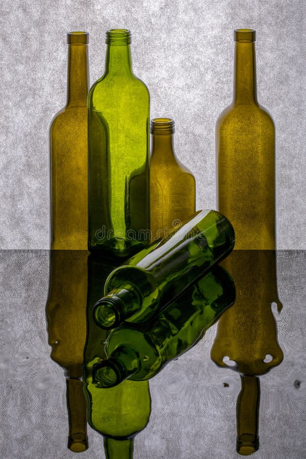 Still Life with Colored Bottles on a Reflective Surface Stock Photo ...