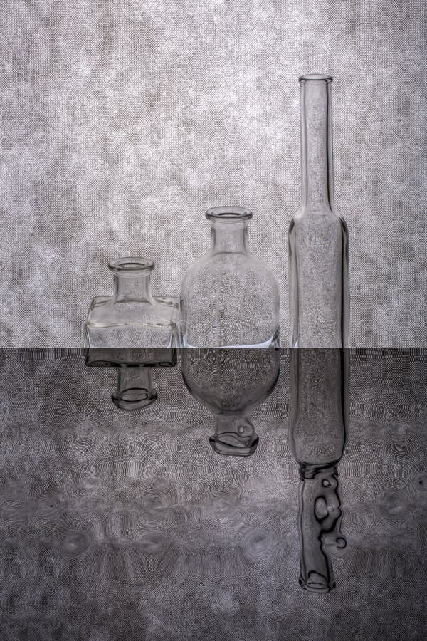 Still Life with Colored Bottles on a Reflective Surface Stock Image ...