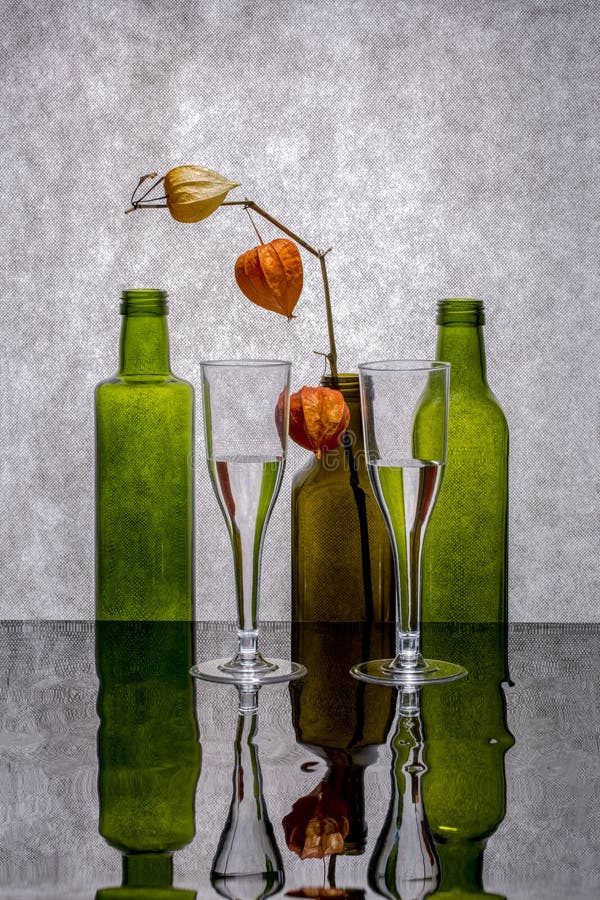 Still Life with Colored Bottles on a Reflective Surface Stock Photo ...