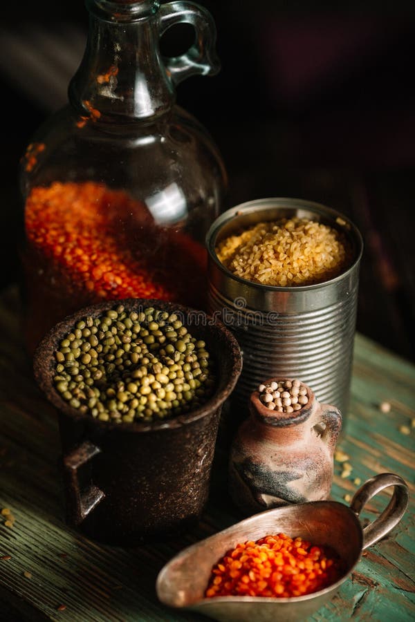 Still Life with Different Containers for Grain on Wood Background Stock ...