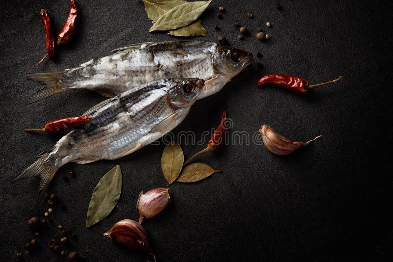 Still Life of Dried Fish with Spices on a Black Background Stock Photo ...