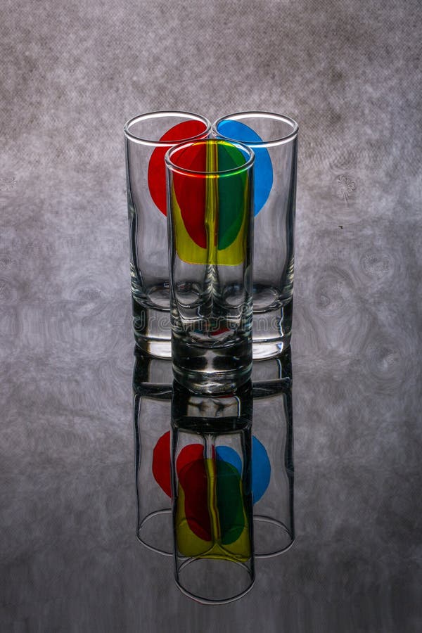 Still Life with Glass Objects with Colored Spots on a Reflective ...