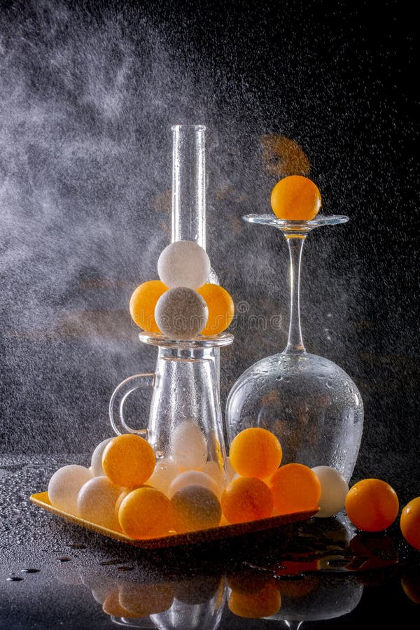 Still Life with Glasses and Orange Balls with Water Spray Stock Photo ...