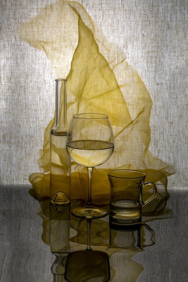 Still Life with Glassware on a Reflective Surface with Fabric Stock ...