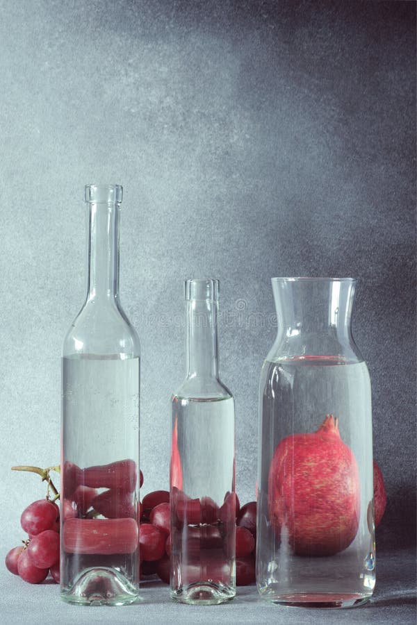 Still Life of Grapes Seen through Water in Clear Glass Bottles Stock ...