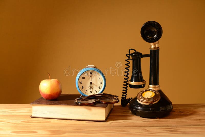 Still Life, Old Phone, Book, Apple and Alarm Clock on a Wooden Table ...