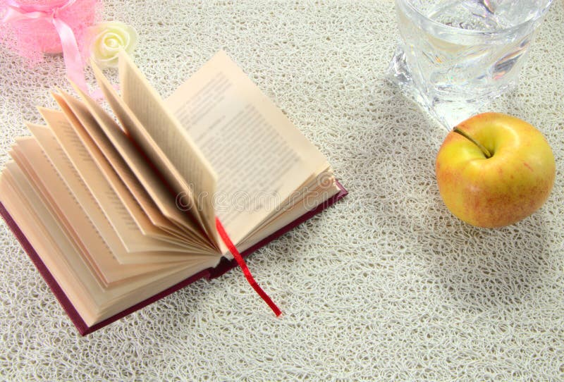 Still Life of an Open Book and an Apple on the Table. Stock Image ...