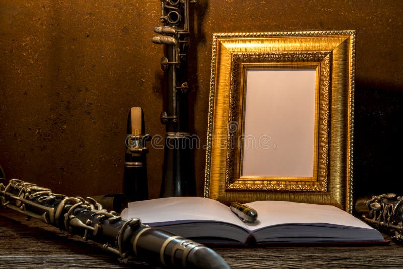 Still Life of Picture Frame on Wooden Table with Clarinet Stock Image ...