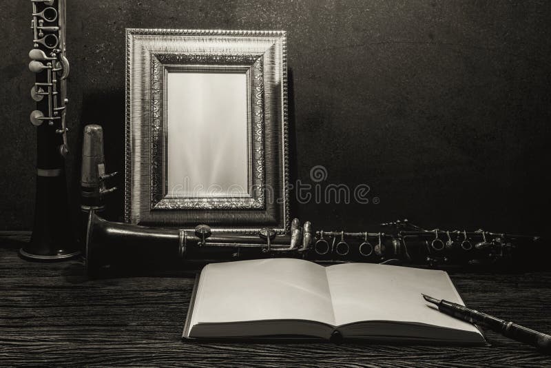 Still Life of Picture Frame on Wooden Table with Clarinet Stock Photo ...