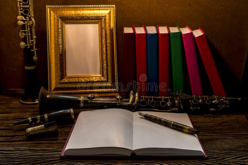 Still Life of Picture Frame on Wooden Table with Clarinet Stock Photo ...