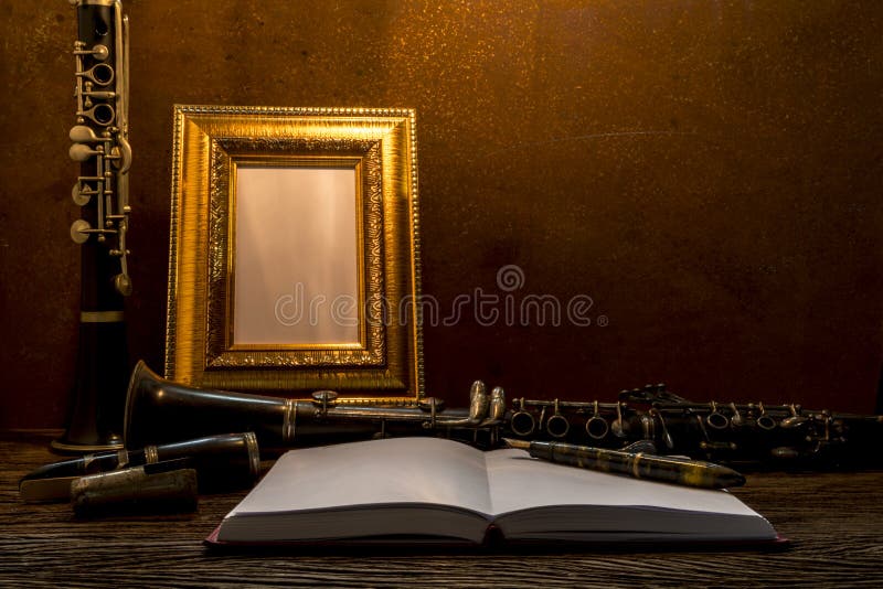 Still Life of Picture Frame on Wooden Table with Clarinet Stock Photo ...