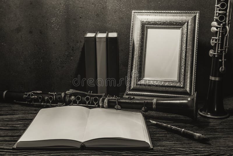Still Life of Picture Frame on Wooden Table with Clarinet Stock Photo ...