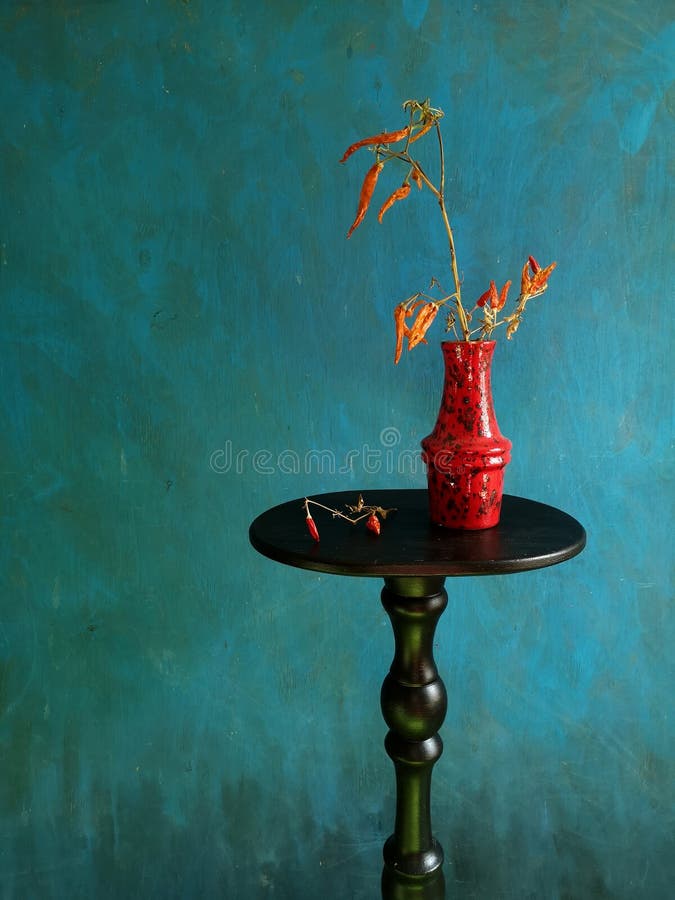 Still Life with Red Hot Chili Peppers in Red Vase on Table Stock Photo ...
