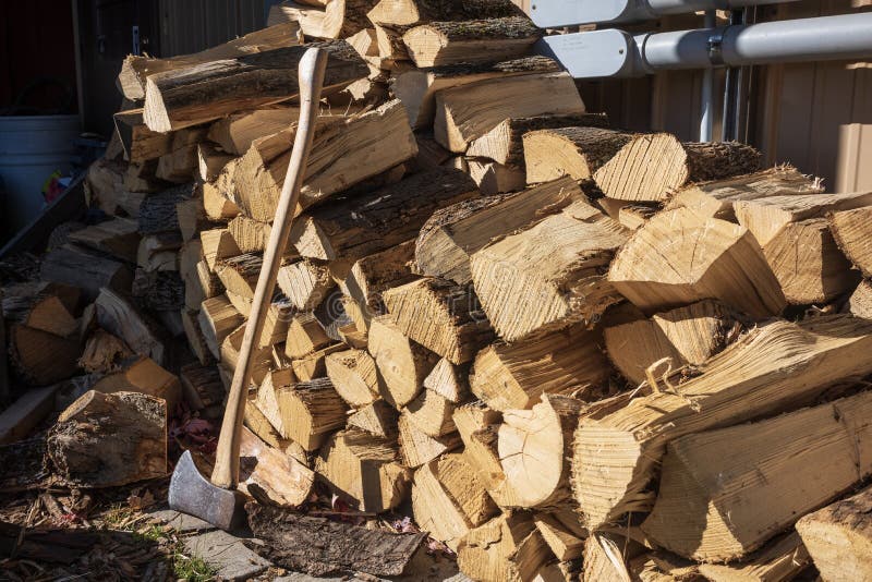 Wood Pile and Axe Along the Side of a Shed Stock Photo - Image of ...