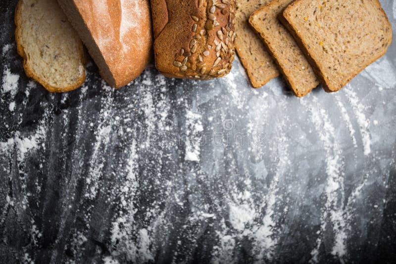Still Life of Various Breads on a Dark Background with Flour Stock ...