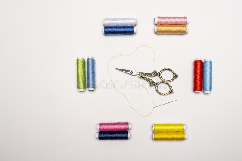 A Needle with Yellow Thread Threaded Together with a Spool of the Same ...