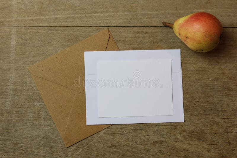 A Blank Message Card on a White and Brown Envelope with a Fresh Pear ...