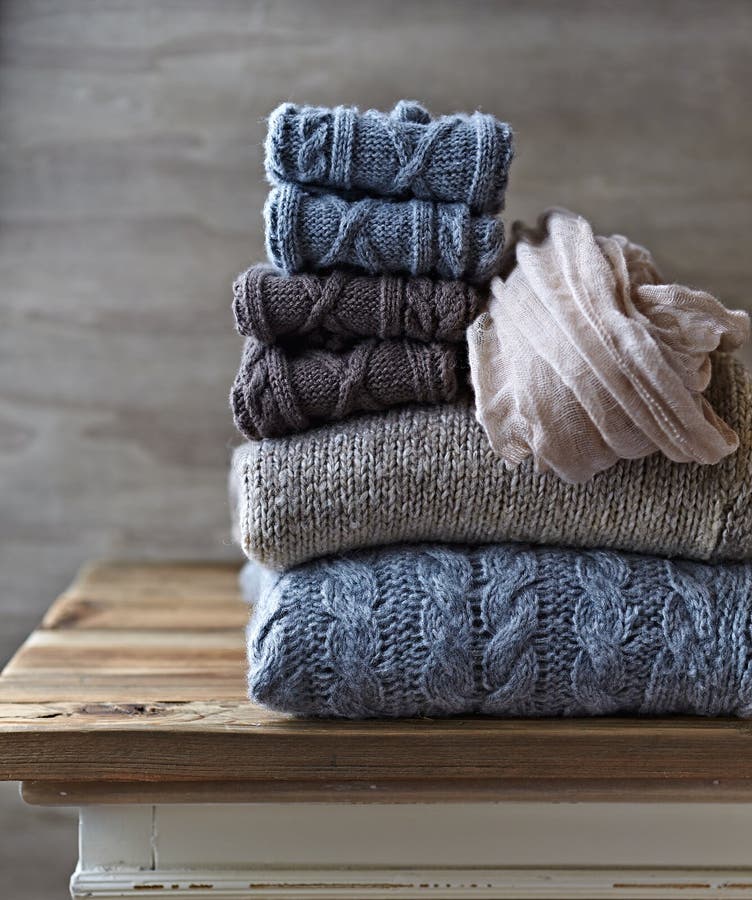 Pile of Knitted Winter Clothes and Wool Sweaters on Wooden Background ...