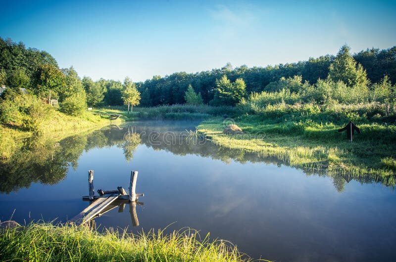 Still river in the meadow stock photo. Image of water - 76438832