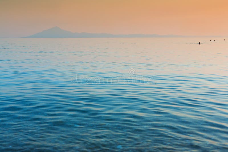 Still Sea and Distant Island Stock Photo - Image of coast, people: 32309926