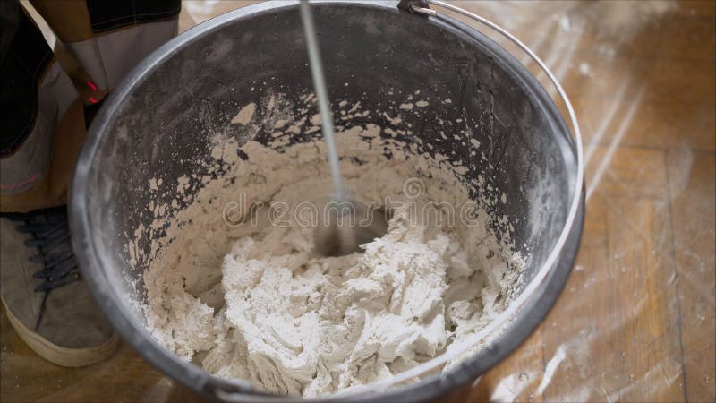 Stir the Building Mix in a Bucket. Stirs the Solution in a Bucket Stock ...