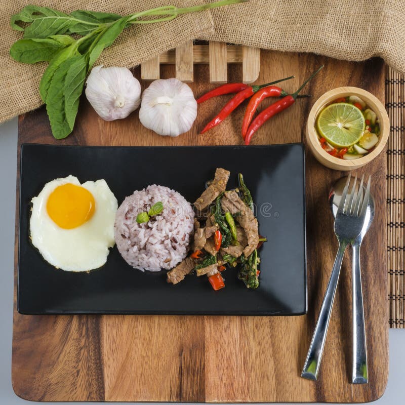 Stir-fried Beef Basil with Fried Egg and Riceberry Rice Stock Photo ...