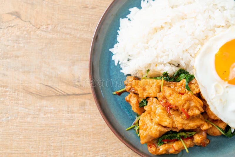 Stir-fried Fried Fish with Basil and Fried Egg Topped on Rice Stock ...