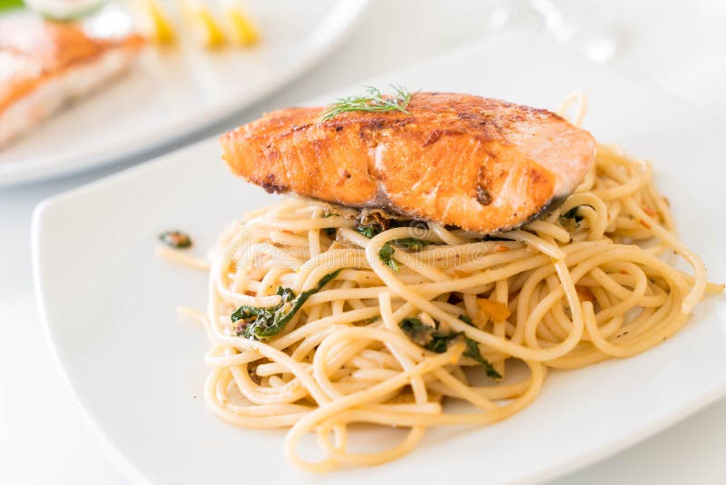 Stir-fried Spicy Spaghetti with Salmon Stock Photo - Image of black ...