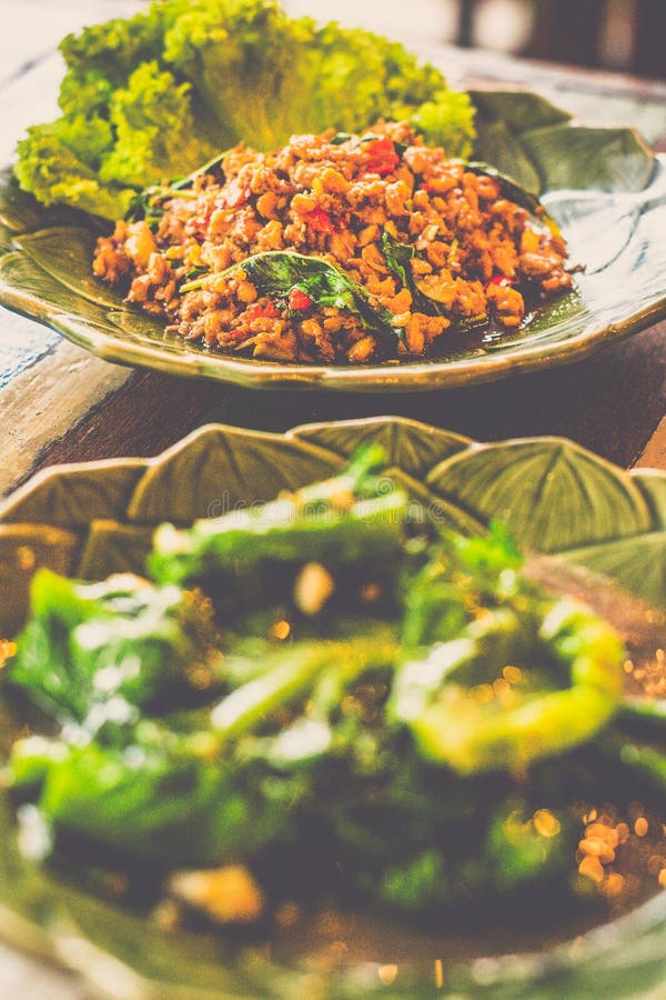 Stir-fry Chicken with Basil and Red Chilli Padi and Served with Raw ...