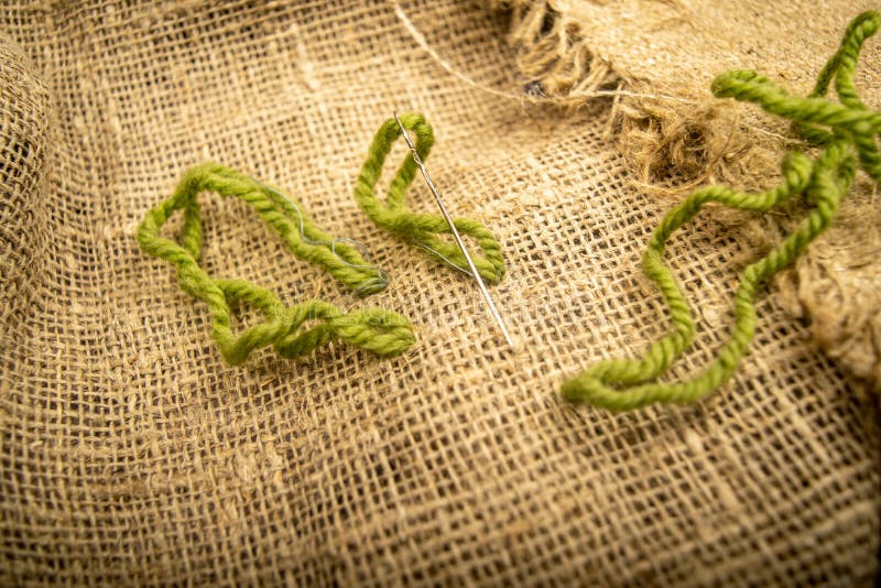 Stitches of Green Thread on the Burlap with a Rough Texture. Close Up ...