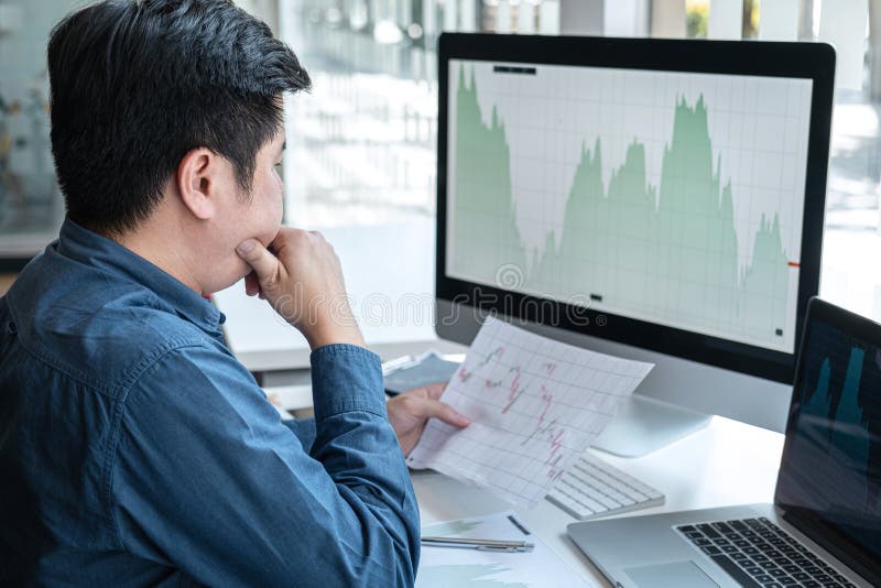 Stock Exchange Market Concept, Stock Broker Looking at Graph Working ...