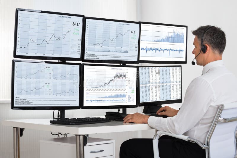 Stock Market Broker Looking at Graphs on Multiple Screens Stock Photo ...
