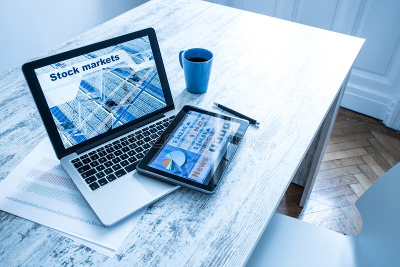 Stock Market Trading App on a Tablet PC and Laptop PC Stock Photo ...