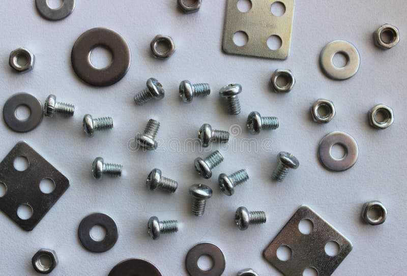 Many Scattered Hardware Items on a White Surface of Workbench Stock ...