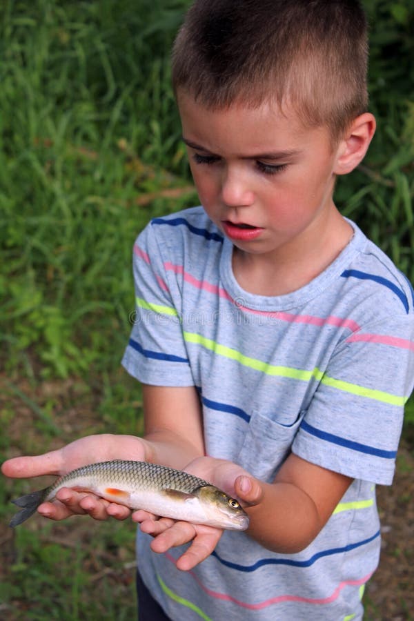 Stock Photo of Little Boy with Fish in Hands Stock Photo - Image of ...