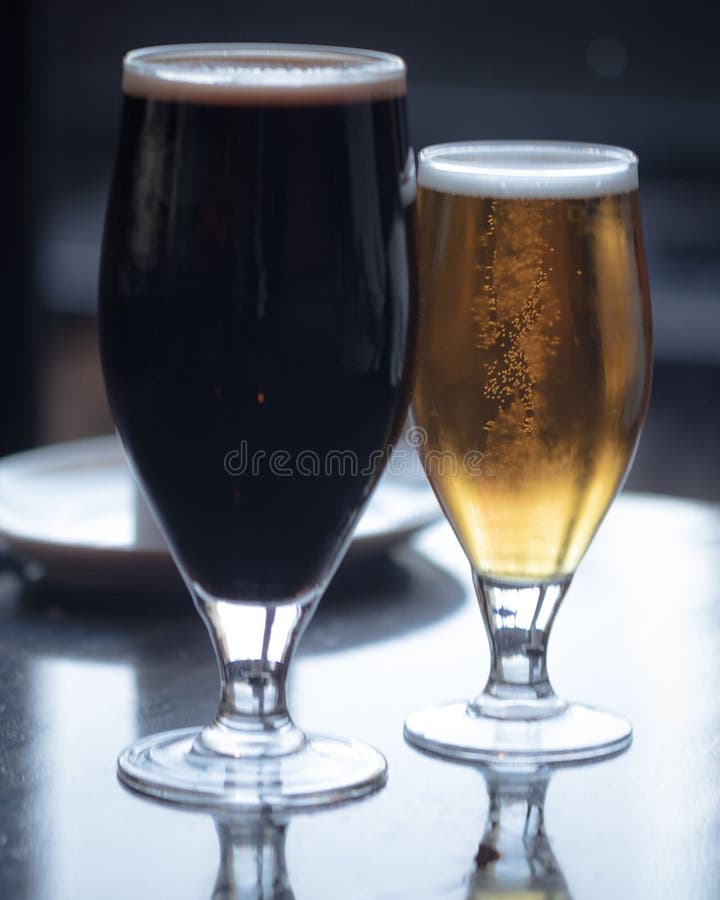 A Vertical Shot of Two Different Beers Stock Photo - Image of froth ...
